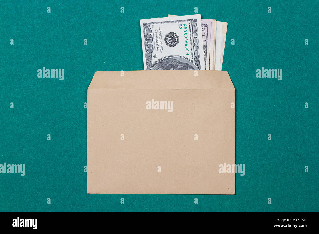 cash in an envelope on a green background Stock Photo - Alamy