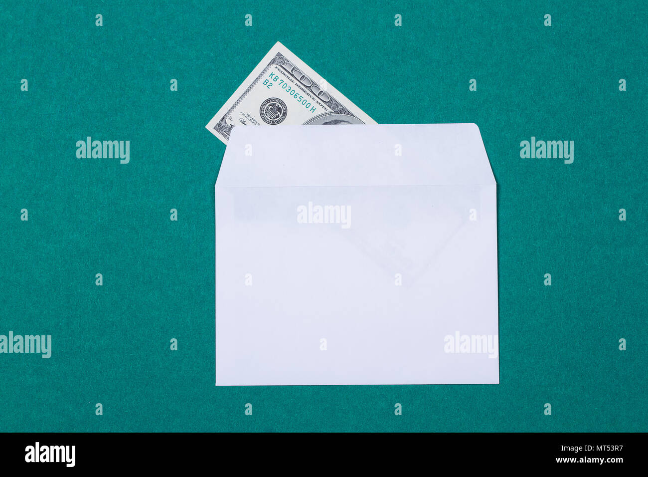 cash in an envelope on a green background Stock Photo - Alamy