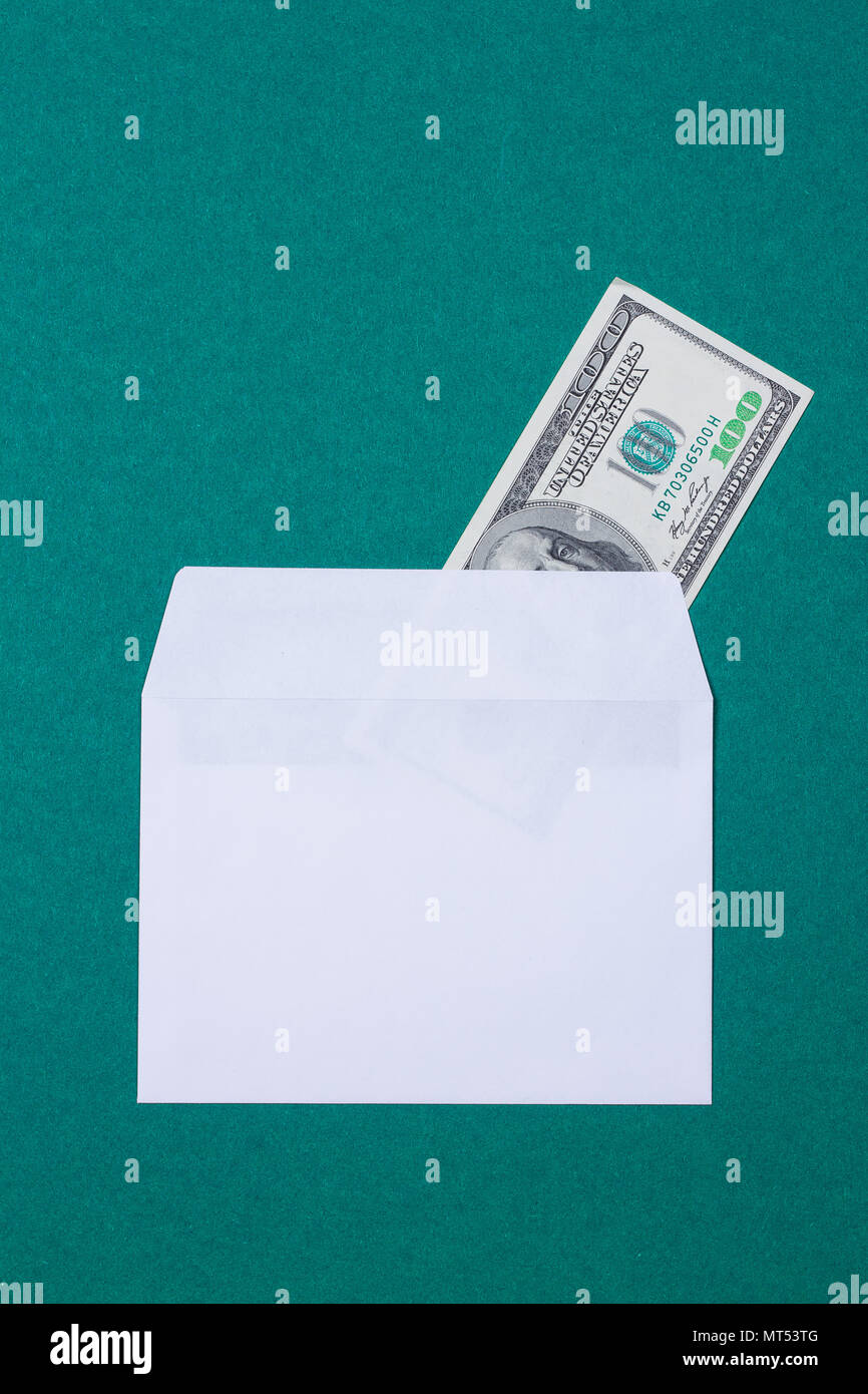 cash in an envelope on a green background Stock Photo - Alamy