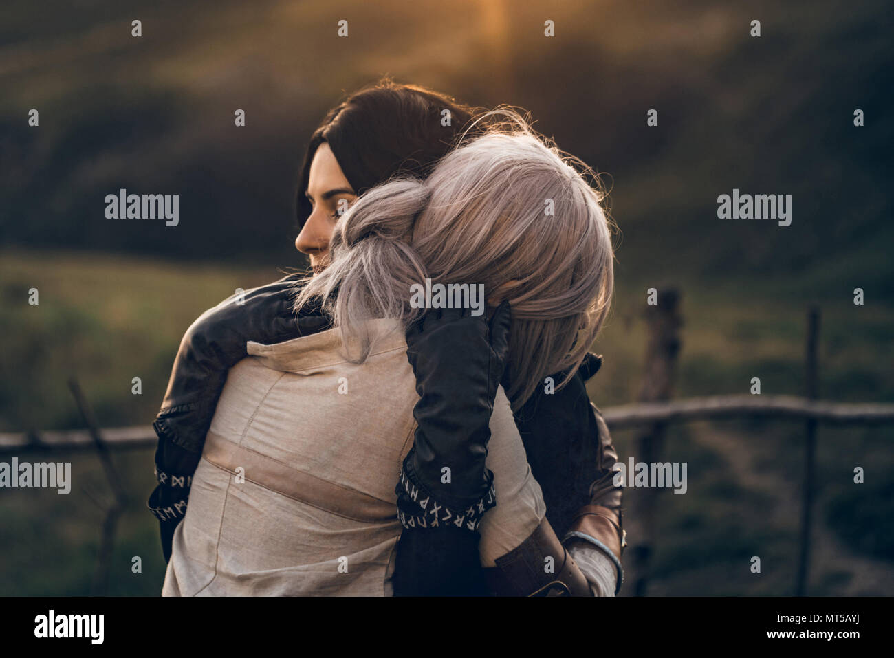 Fantasy cosplay two beautiful girls hug in nature Stock Photo - Alamy