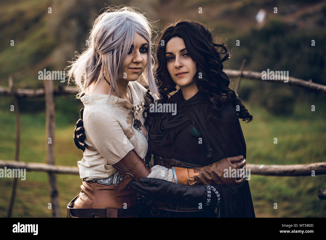 Fantasy cosplay two beautiful girls hug in nature Stock Photo - Alamy