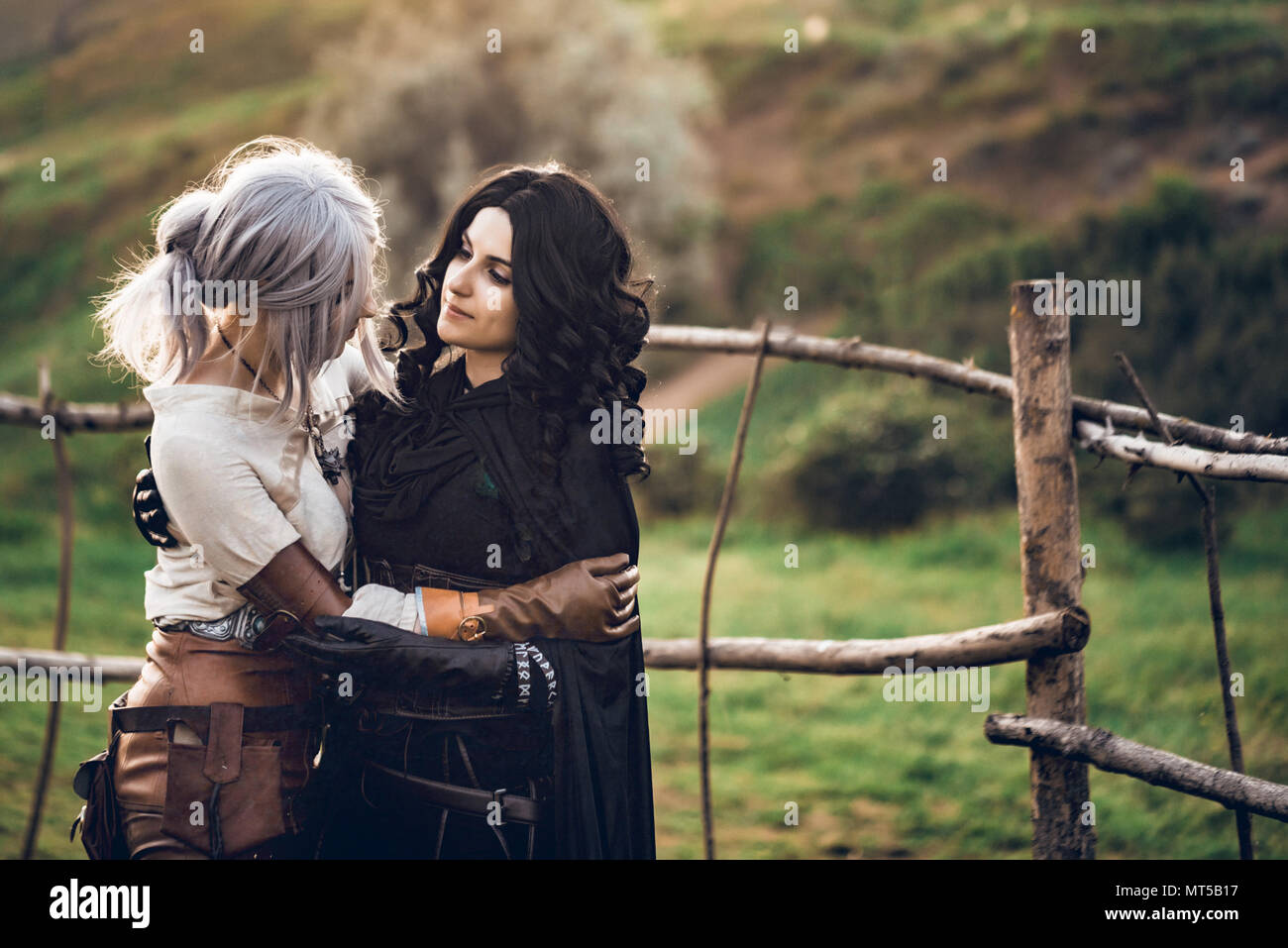 Fantasy cosplay two beautiful girls hug in nature Stock Photo - Alamy