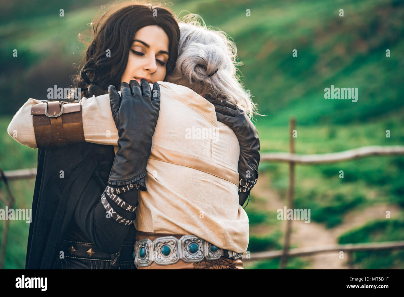 Fantasy cosplay two beautiful girls hug in nature Stock Photo - Alamy