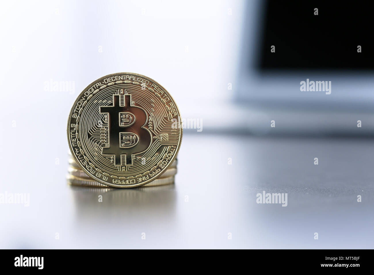 Golden Bitcoin facing the camera in sharp focus, closeup Stock Photo ...