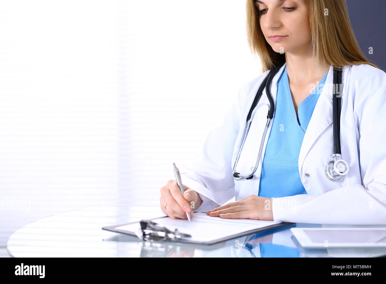 Woman doctor at work in hospital office. Portrait of female physician ...