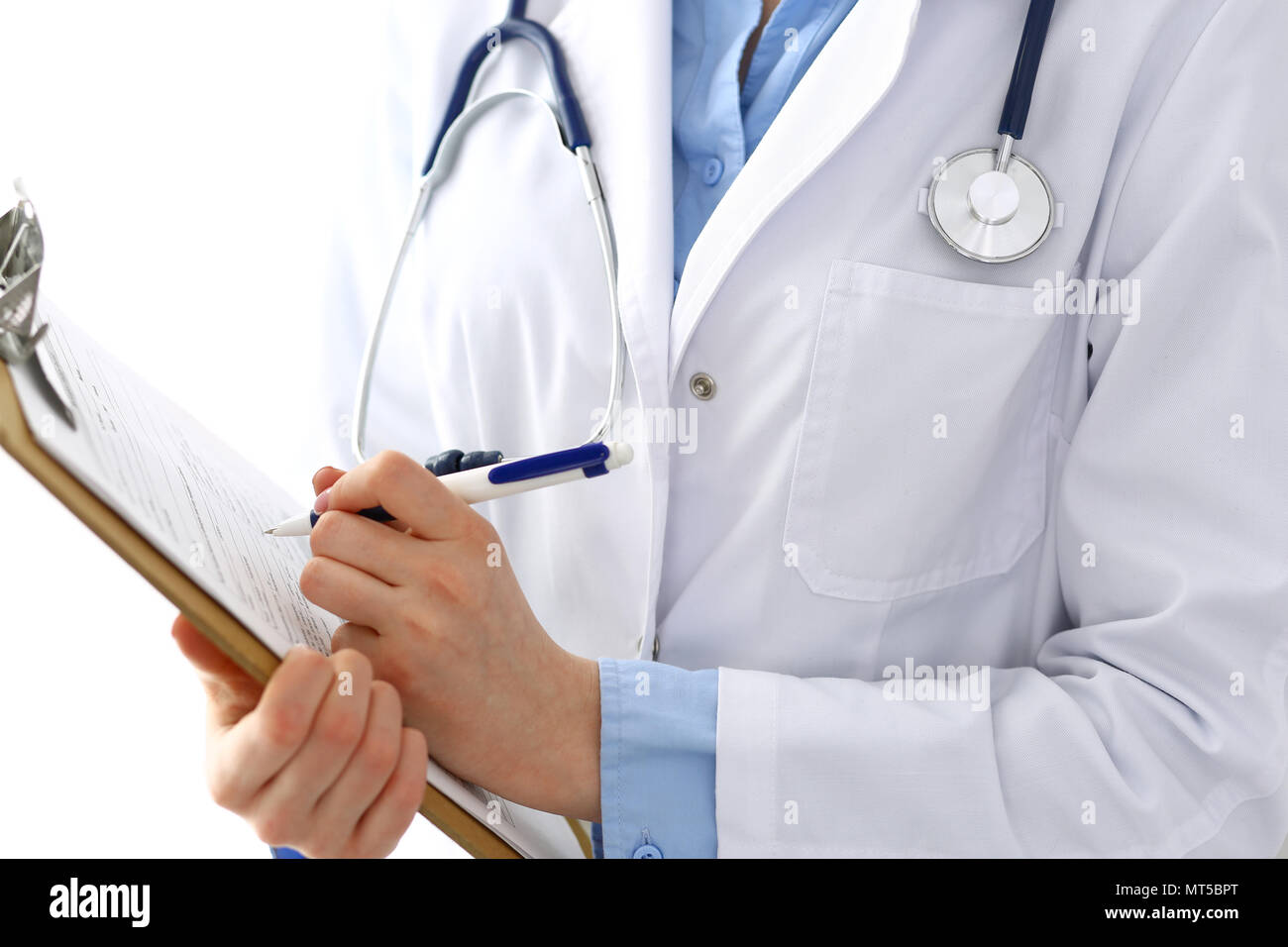 Female doctor filling up medical form on clipboard closeup. Healthcare ...