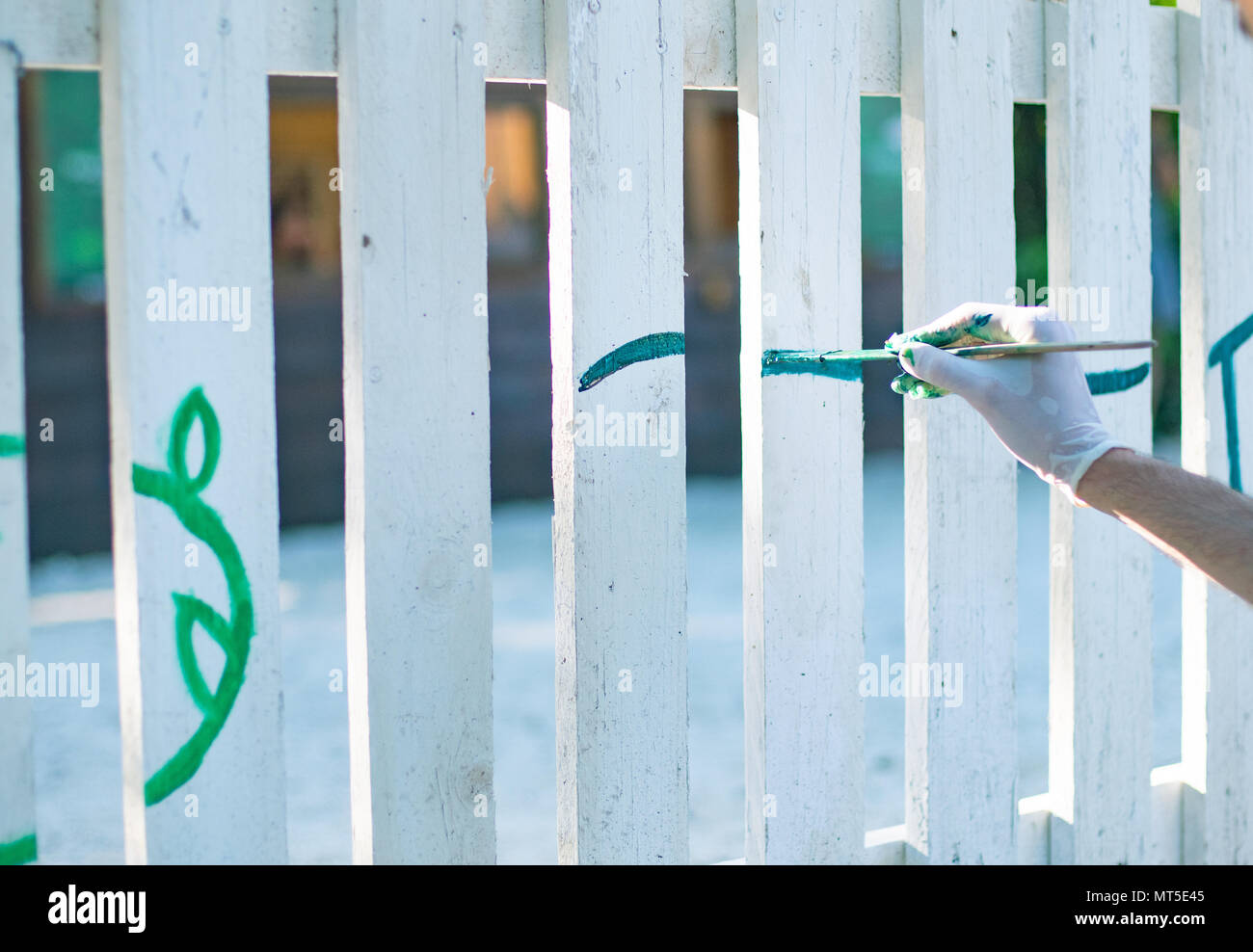 Human hand paint green color on white fence Stock Photo - Alamy