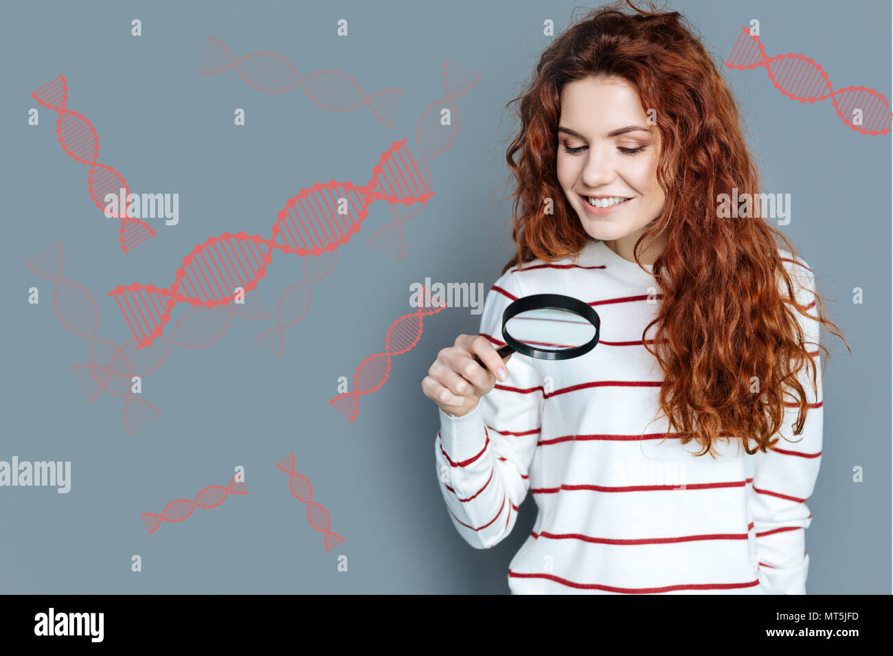 Clever woman studying DNA chains and smiling Stock Photo - Alamy