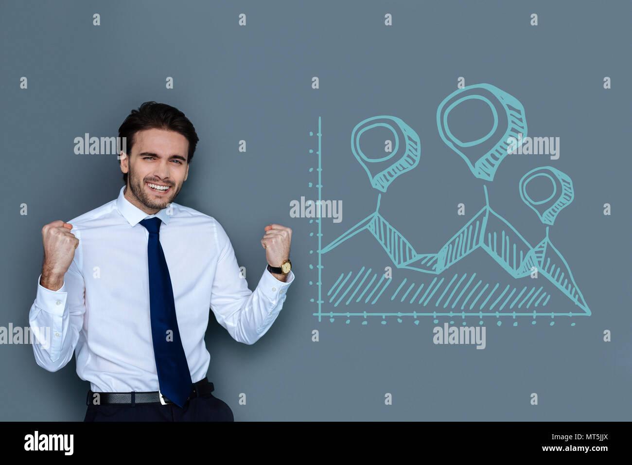 Positive web developer smiling and celebrating his success Stock Photo ... Positive web developer smiling and celebrating his success Stock Photo ...