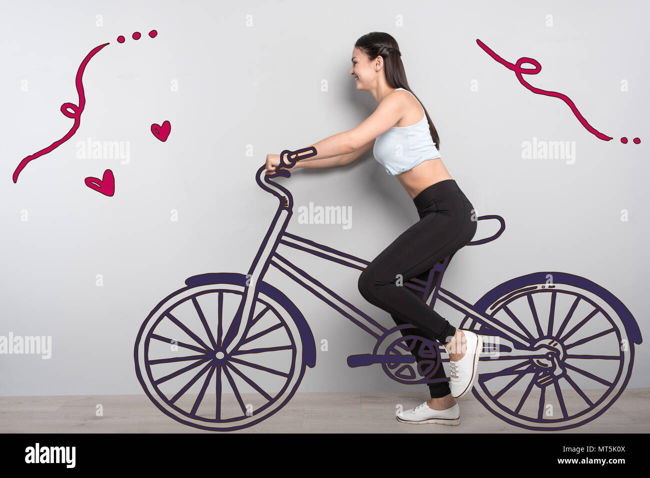 Emotional student riding a bike and feeling happy Stock Photo - Alamy