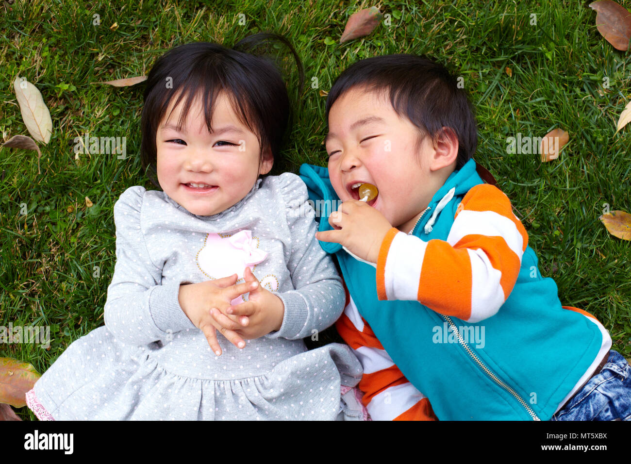 Two happy little asian kids playing outdoor in the sunny park Stock ...