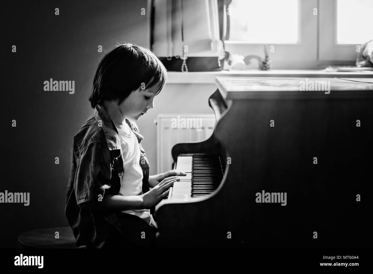 Preschool child, cute boy, playing piano at home, child learning music ...