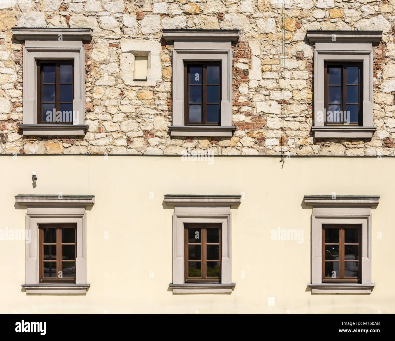 Renovated facade of a medieval house. The ground floor is a plaster ...