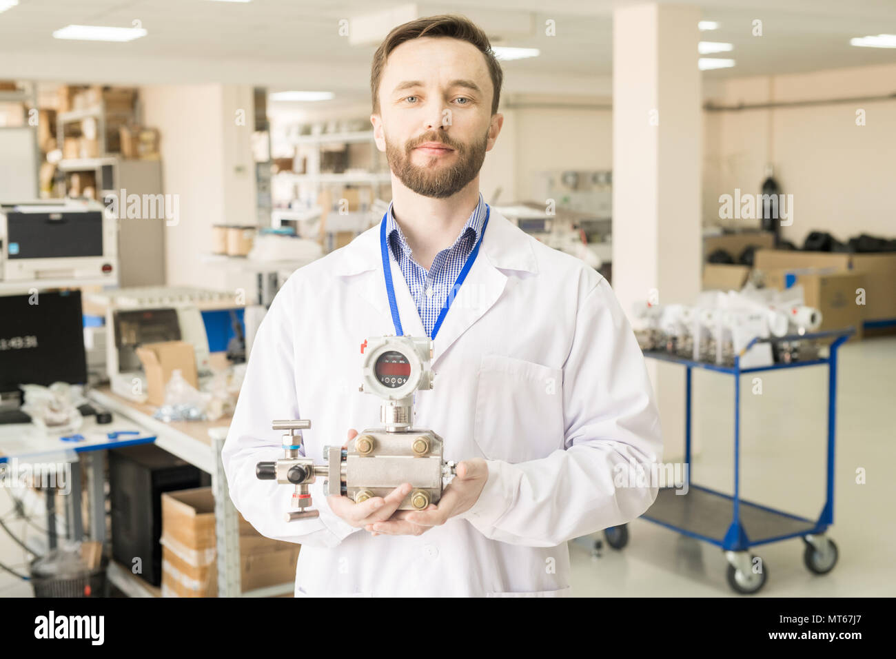 Content engineer holding manometer in quality control office Stock ...