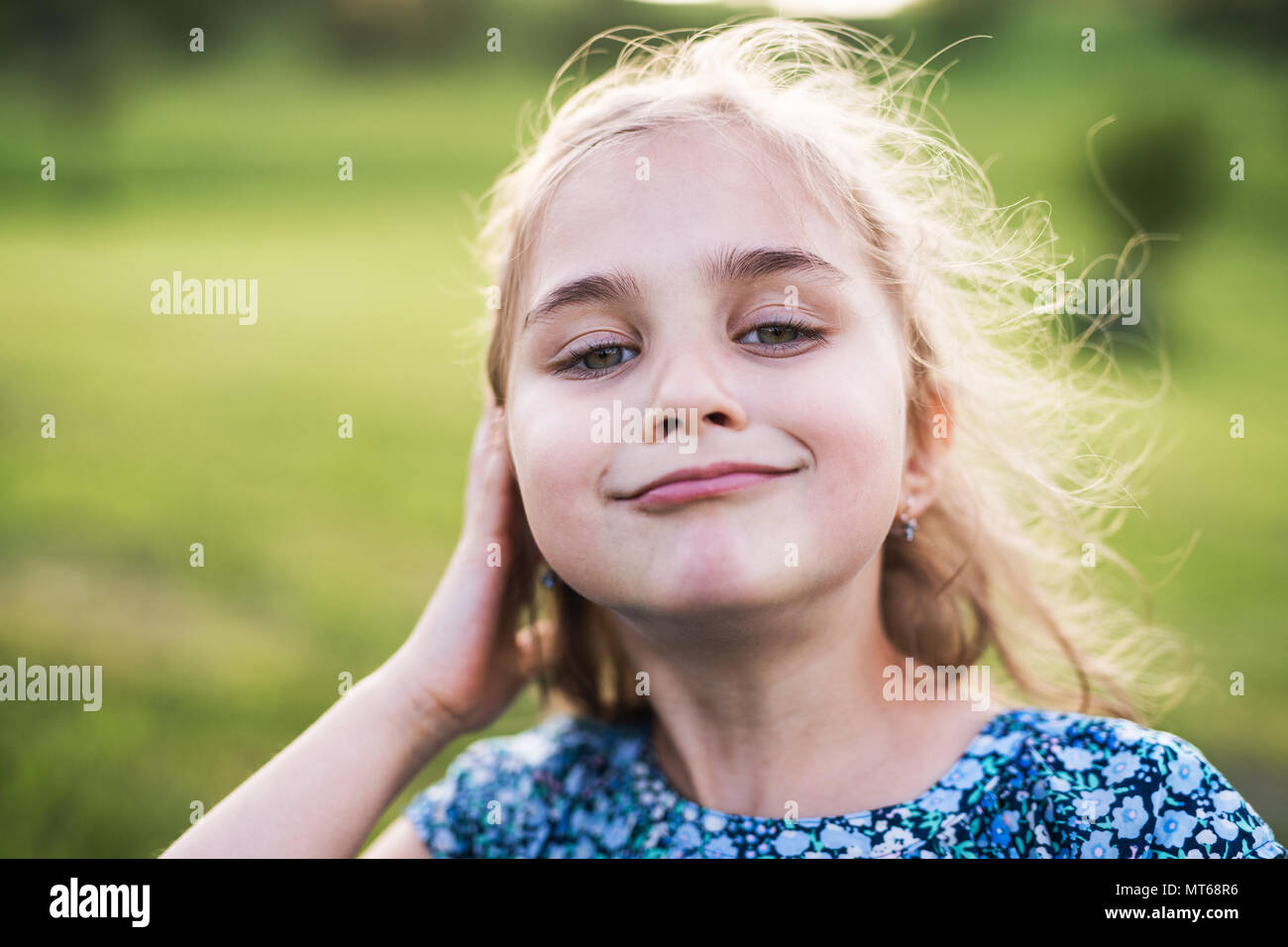A small girl in the garden in spring nature Stock Photo - Alamy