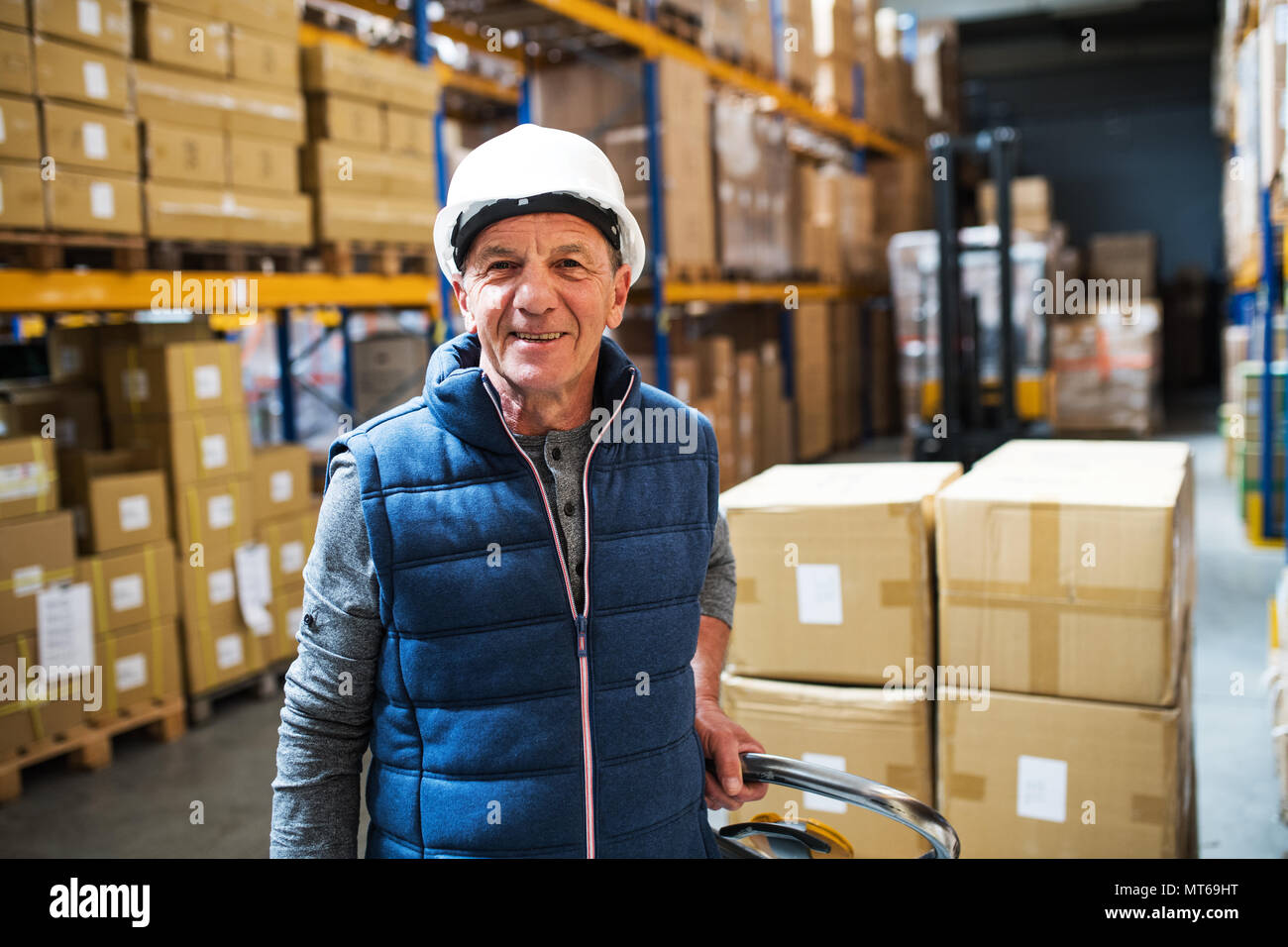 Warehouse pulling pallet truck boxes hi-res stock photography and ...