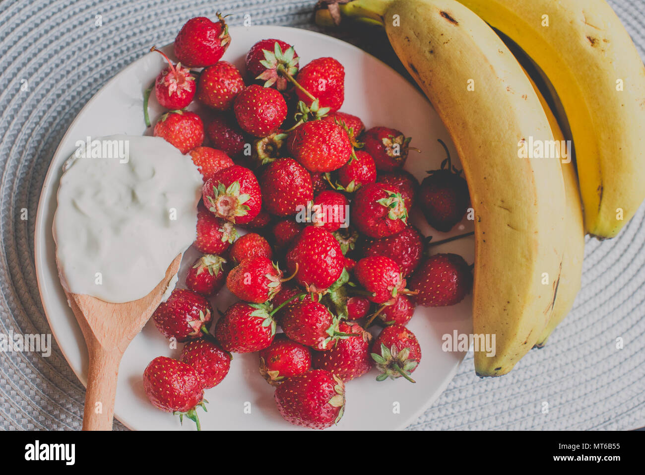 Bunch of bananas and strawberries. Photo toned style Instagram filters ...
