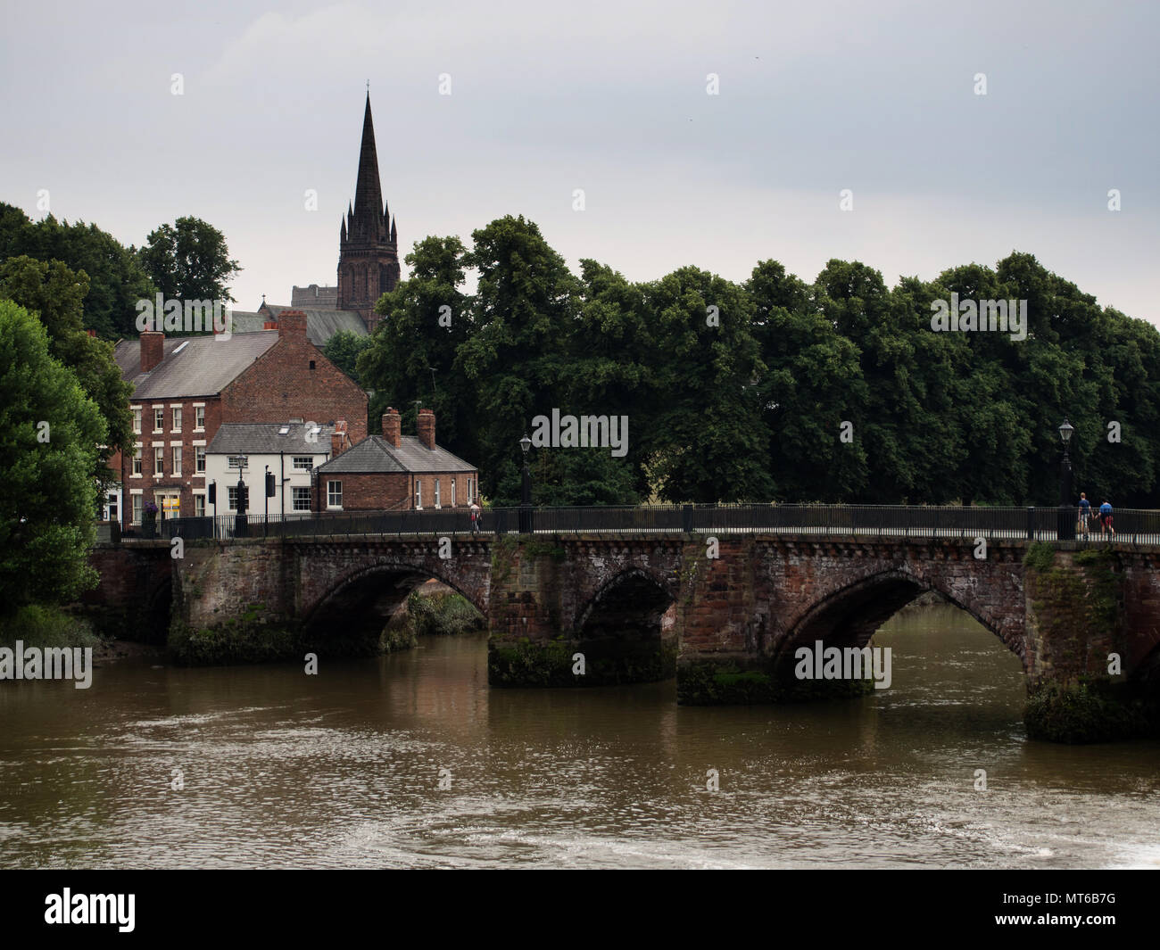 Old Dee Bridge over River Dee, with Parish Church of Saint Mary in the background, in Chester ...