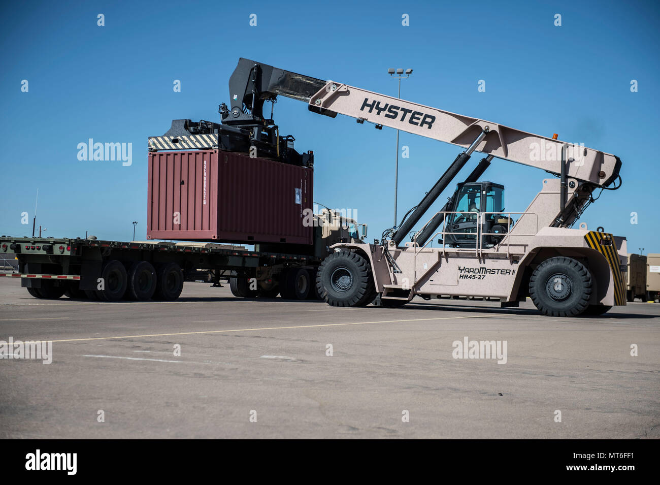 A Hyster 100k Reach Stacker loads equipment at Holloman Air Force Base ...