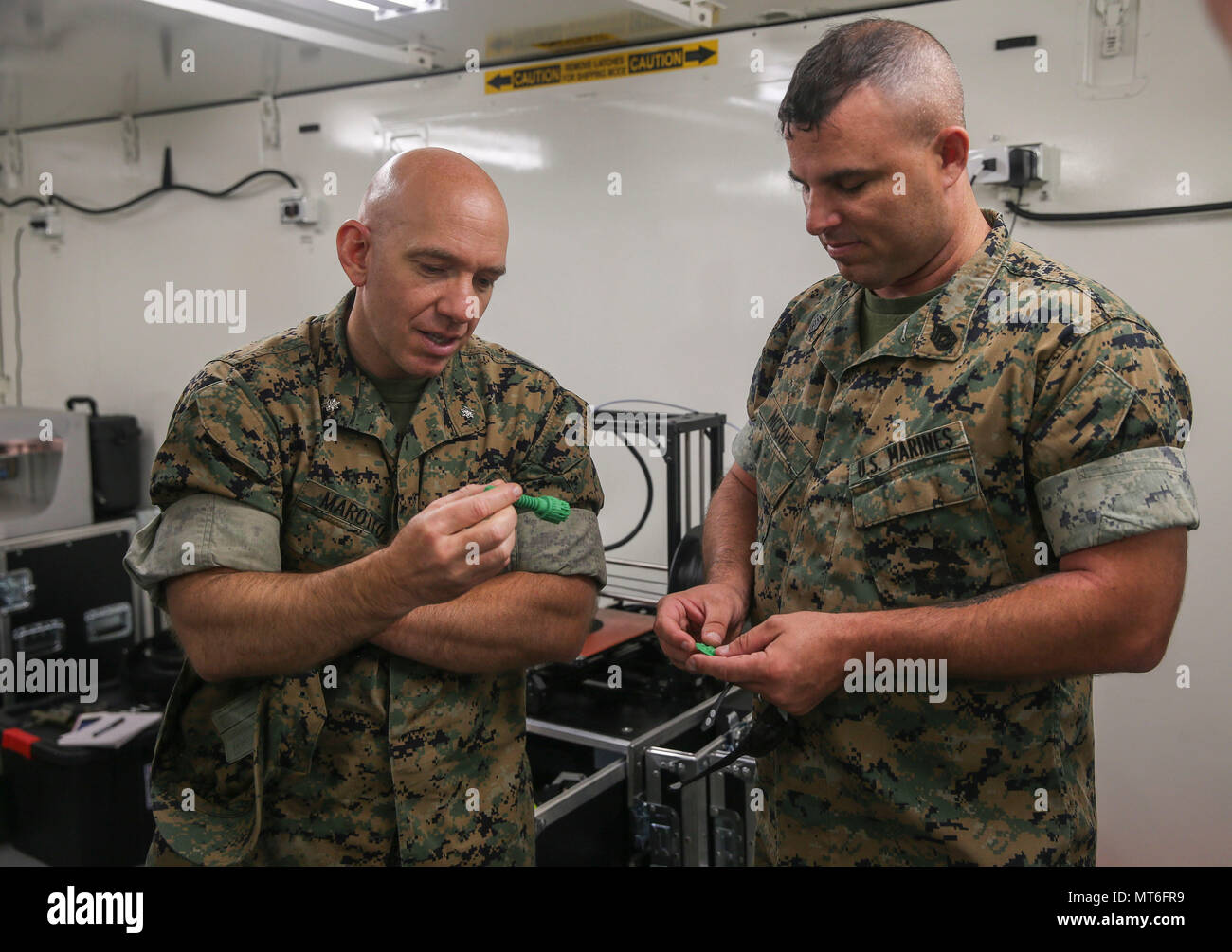 U.S. Marine Corps Lt. Col. Howard Marotto, left, is briefed by Gunnery ...
