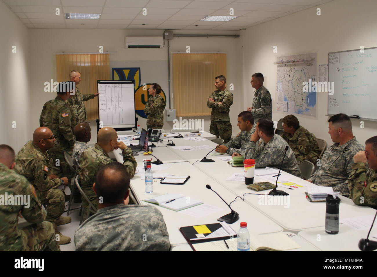 Staff members of the 103rd Expeditionary Sustainment Command (ESC) go ...