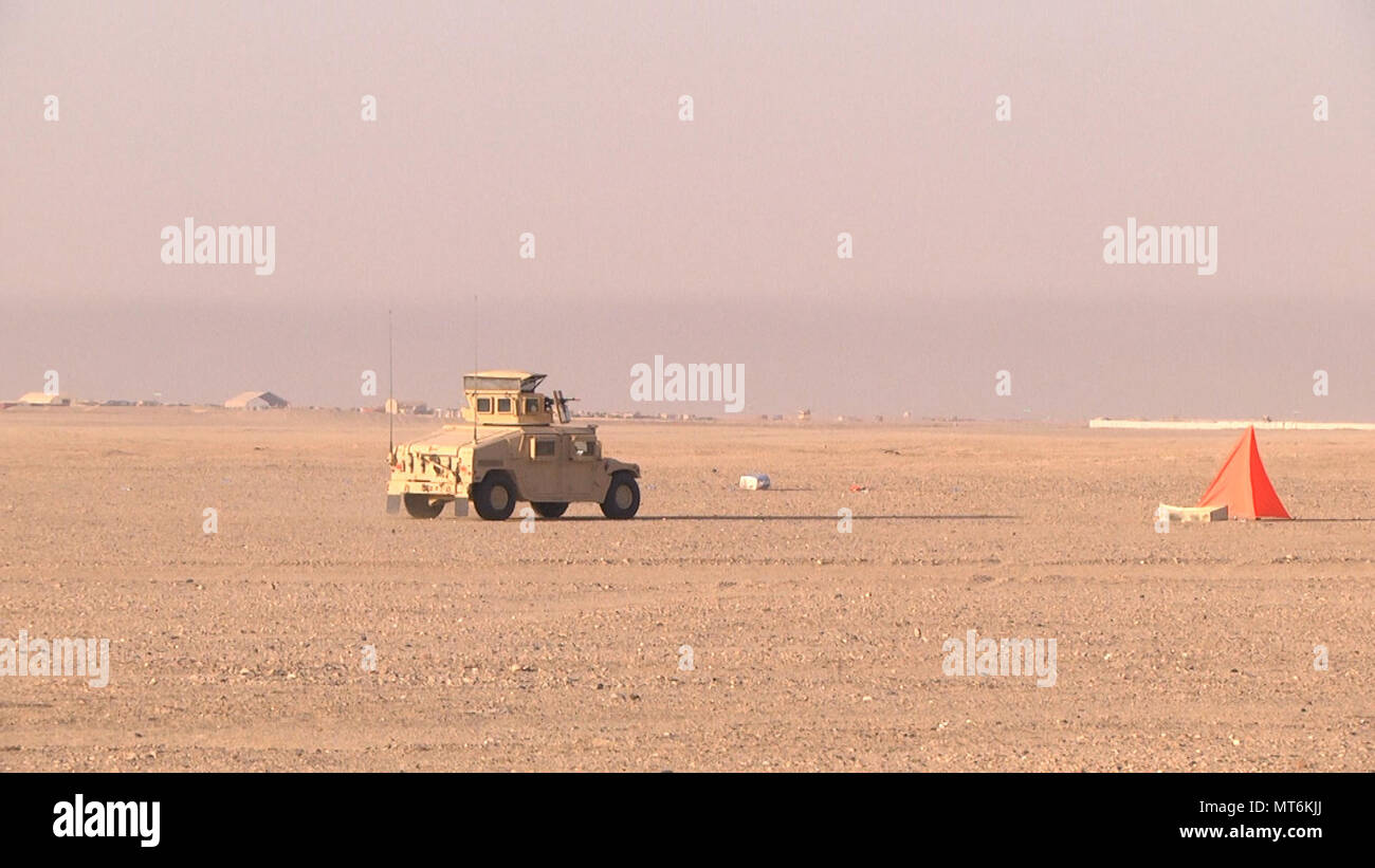 170277-A-RW053-05 An up-armored HUMVEE moves in to guard a package ...