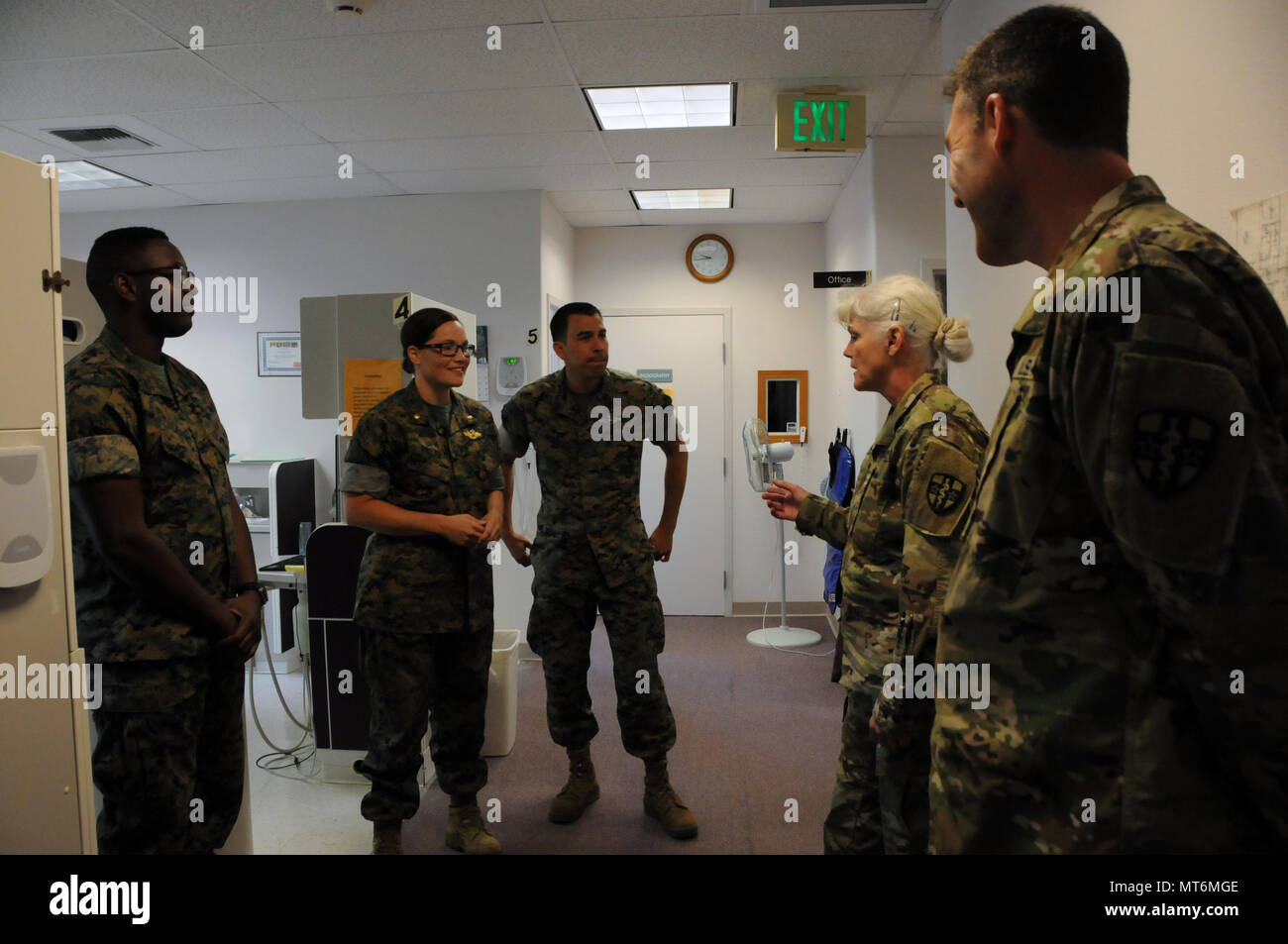 (LEFT TO RIGHT) Petty Officer 3rd Class Anthony Adams, a field medic ...