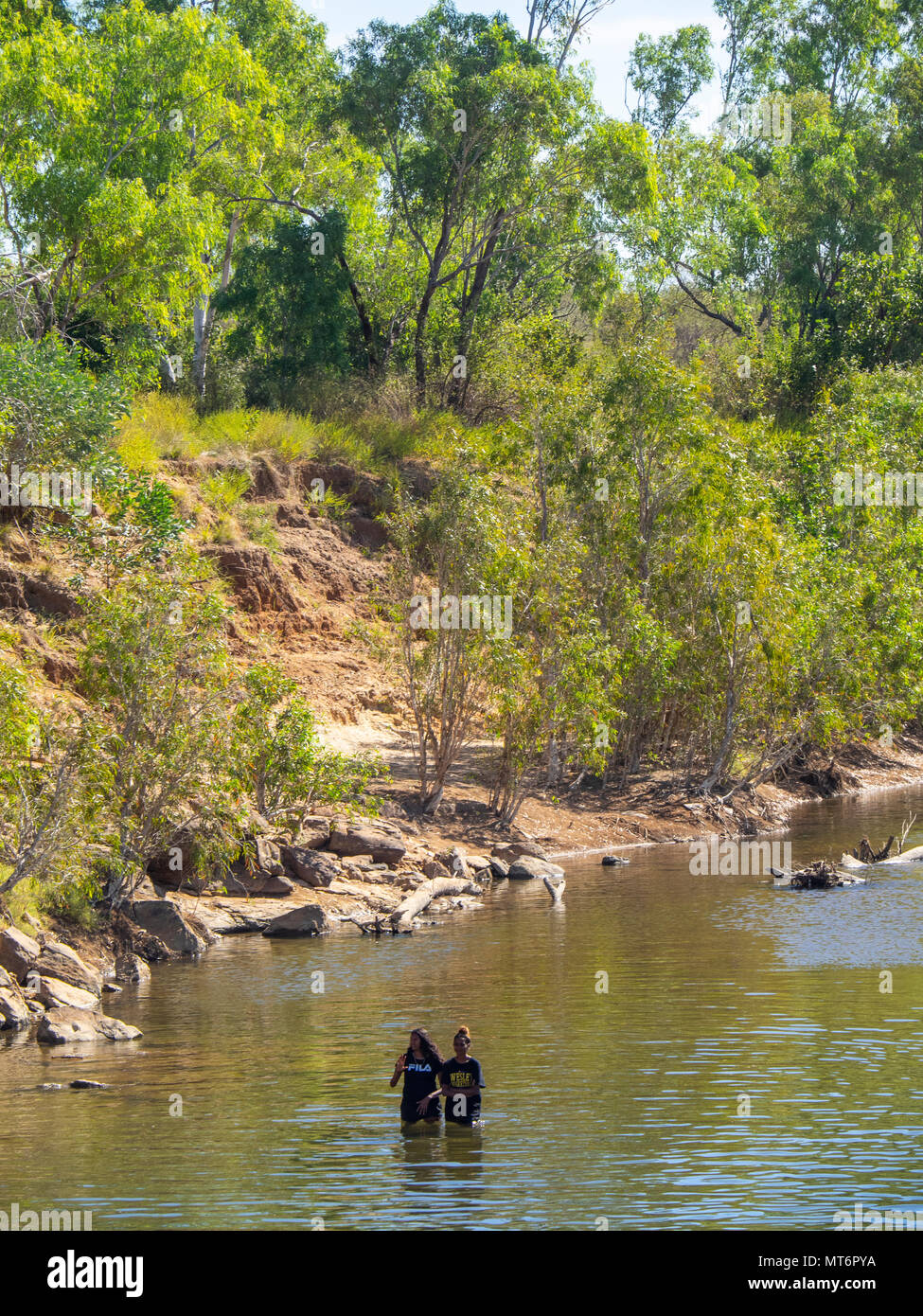 Two indigenous girls standing in the Lennard River, Gibb River Road ...