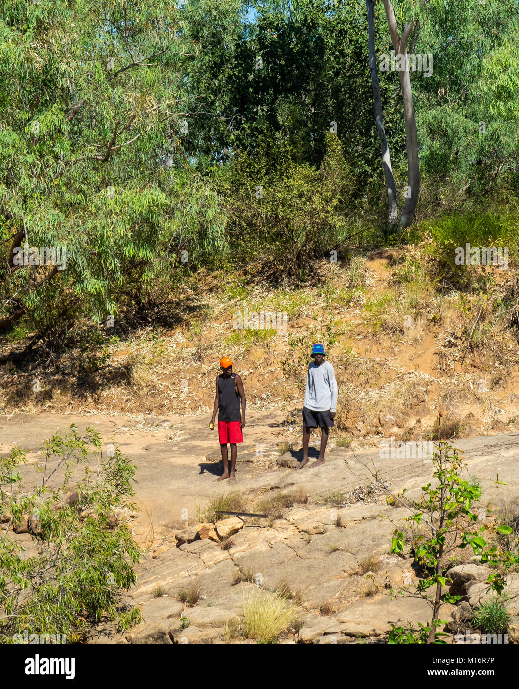 Two indigenous youths standingg by the Lennard River, Gibb River Road ...