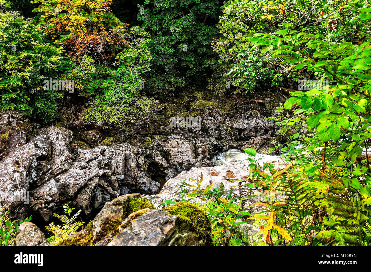 Slabs of angular igneous looking rocks lie at angles one on another at ...