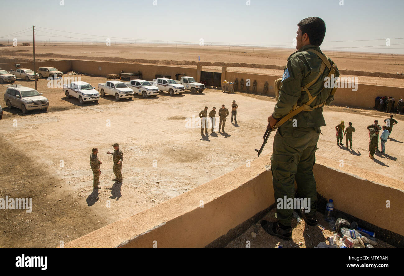 A Raqqah Internal Security Force member stands guard above the RISF ...