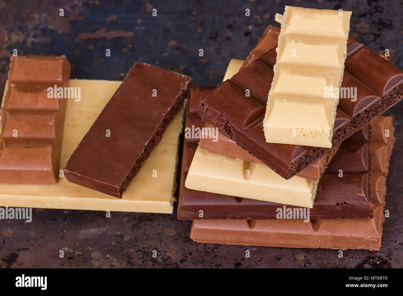 milk, dark and white chocolate bars on grunge background Stock Photo ...