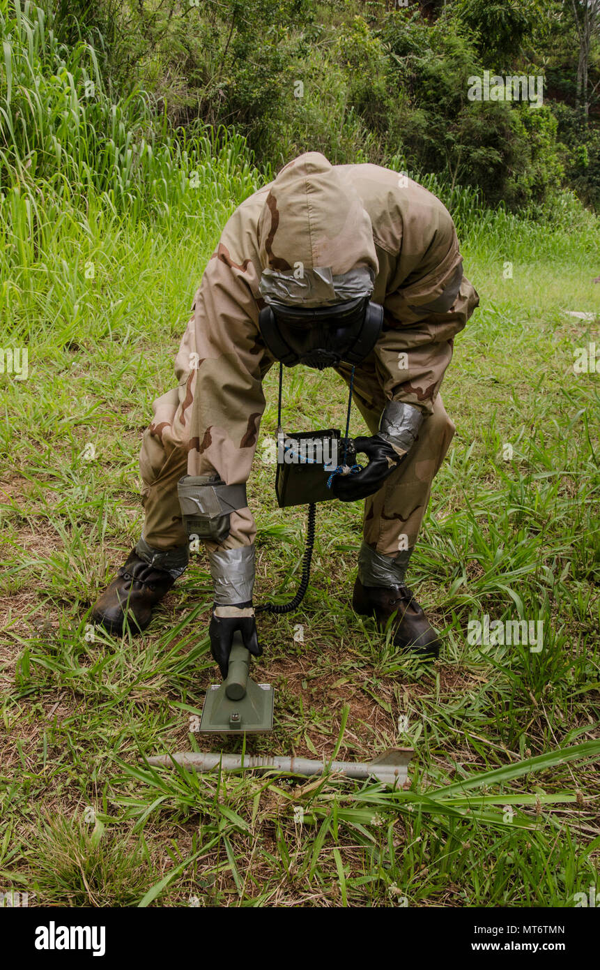 A National Guard EOD technician measures a training ordnance for ...