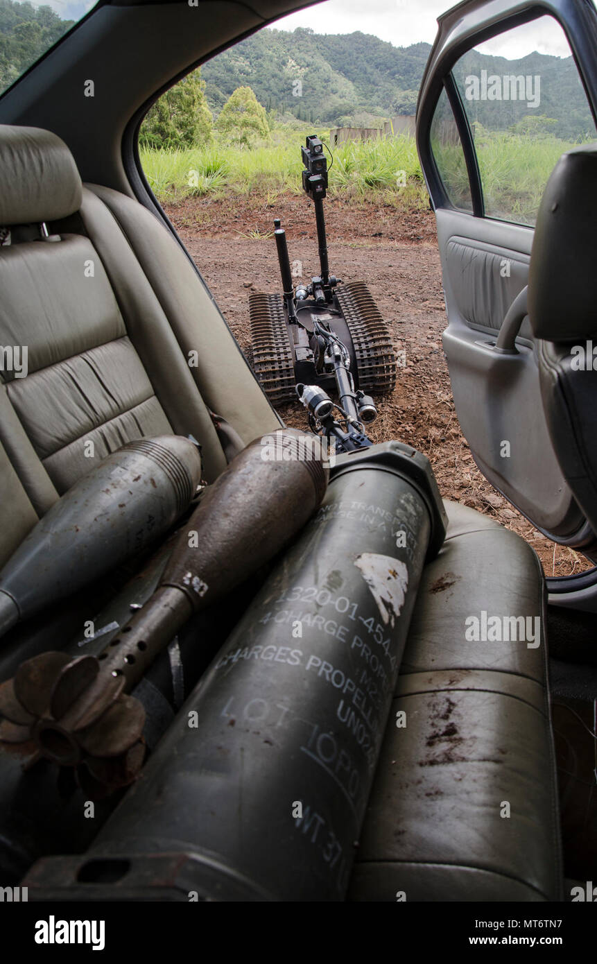 A robot controlled remotely by a National Guard EOD technician ...