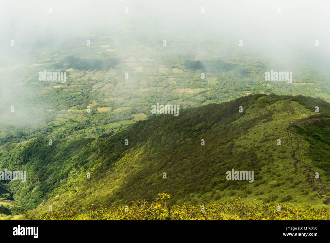 A view down the side of Volcan Concepcion, with a hiking path visible ...