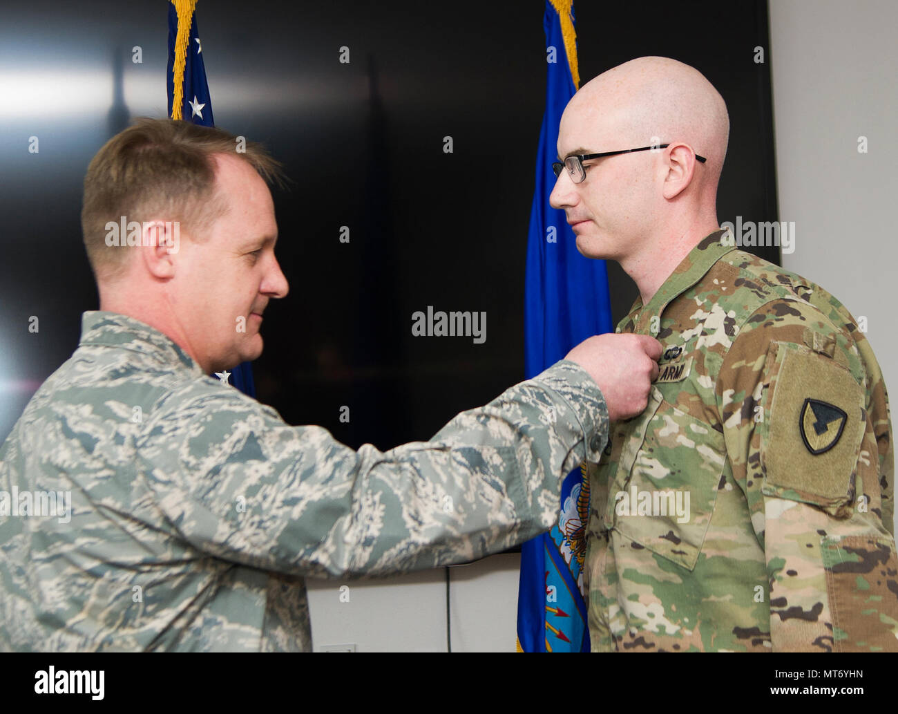 Col. Daniel Knight, left, 673d Mission Support Group commander, pins an ...