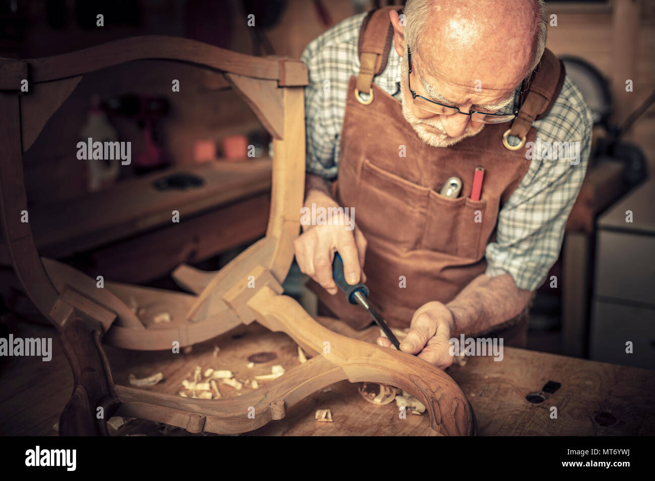 senior woodworker at work with chisel in his workshop Stock Photo - Alamy