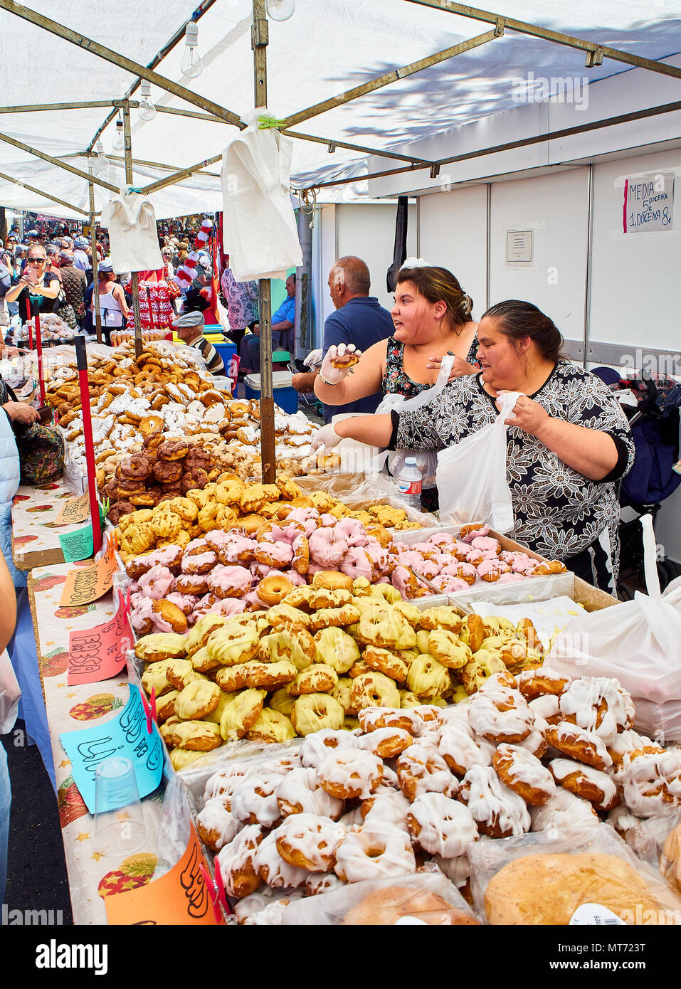 Bakers selling Rosquillas del Santo, typical Spanish sweet, in a bakery ...