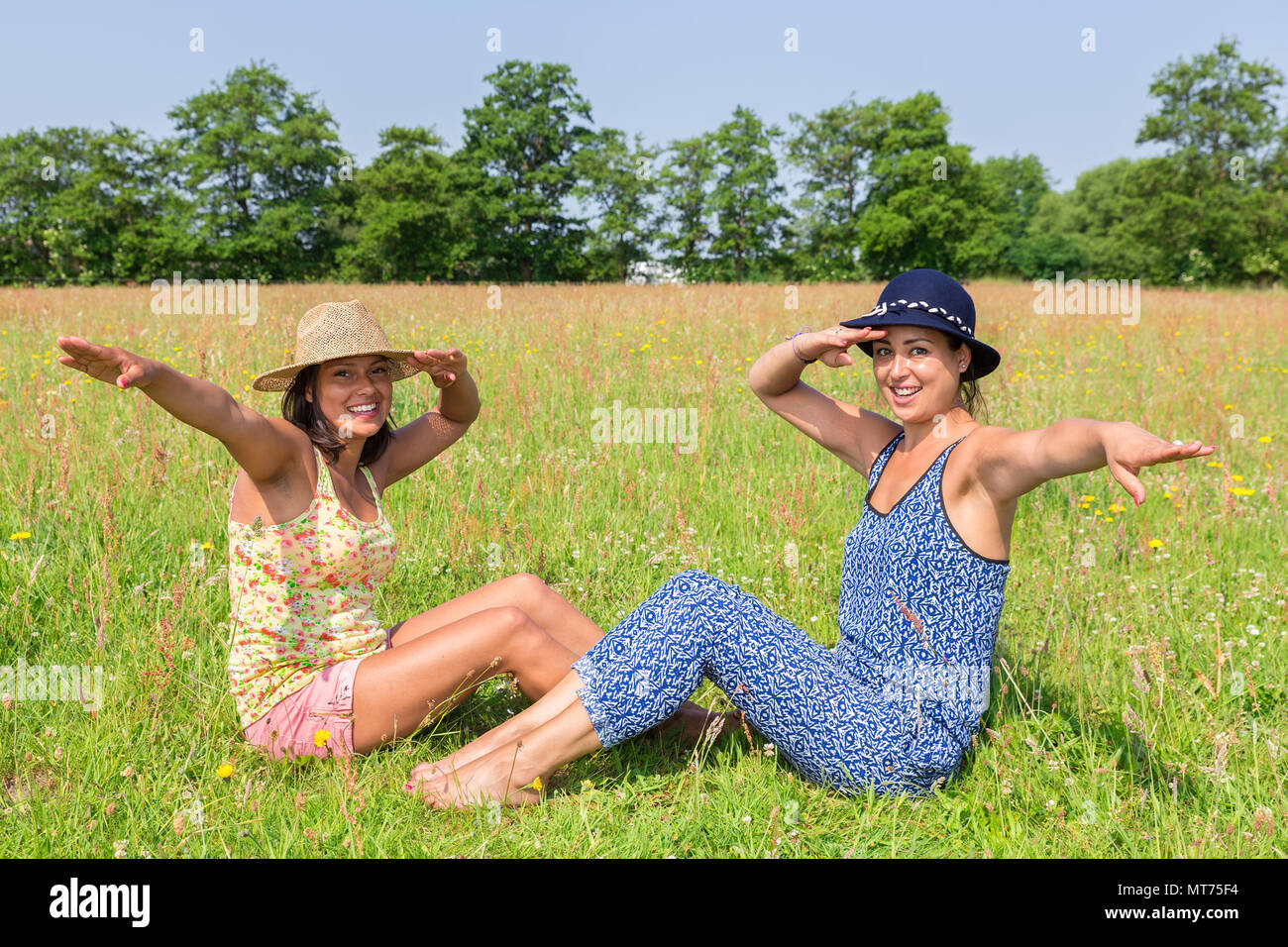 Two friends wearing in hi-res stock photography and images - Alamy
