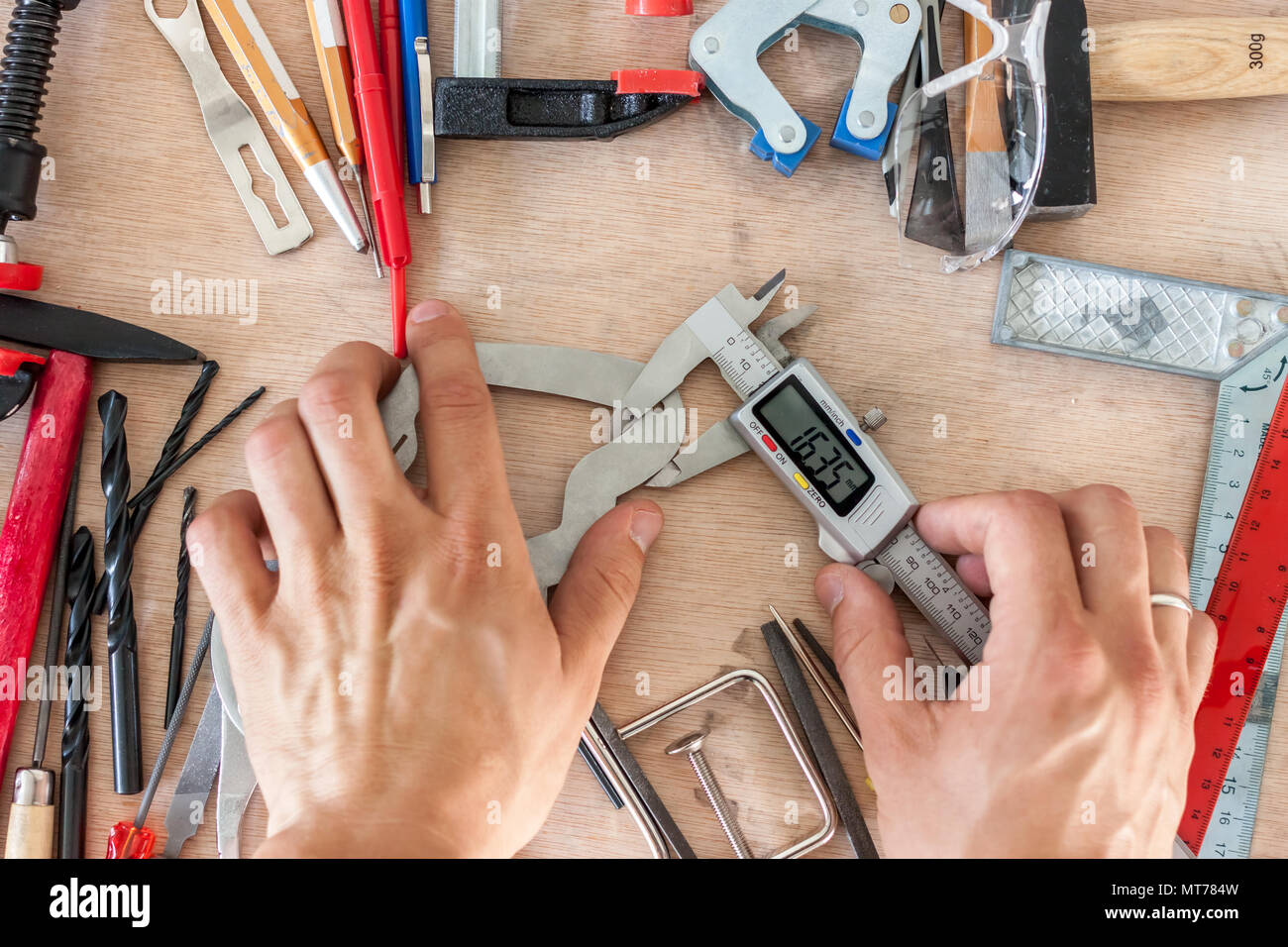 man measuting part with calipers in workshop Stock Photo - Alamy