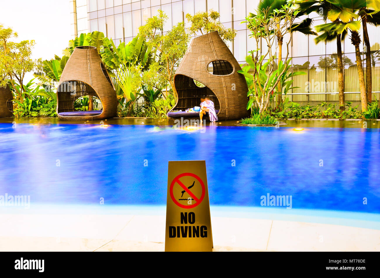 Enjoying and playing at a swimming pool in the hotel residence in ...