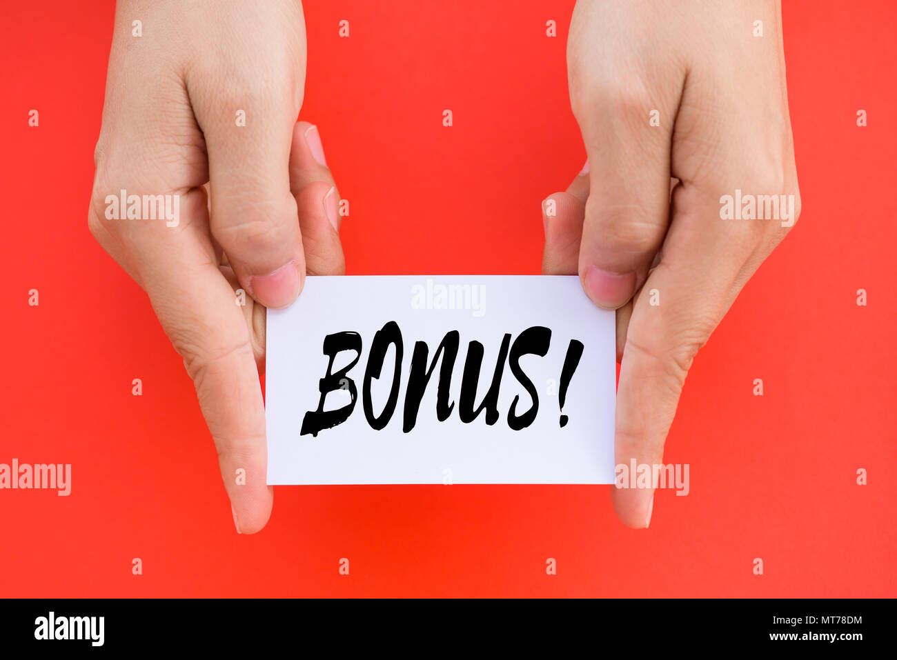 Hand holding Bonus card with red background. Business achievement ...