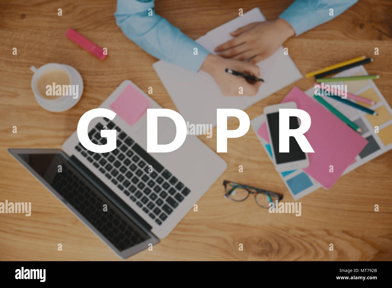 Top view of a blurred manager writing down personal data protection ...