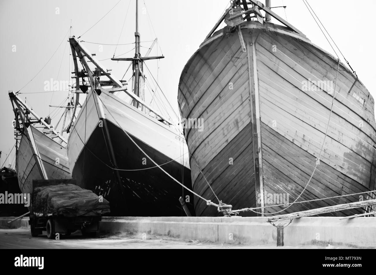 Fisherman and sailor enjoying sunset at a traditional ship boat docking ...