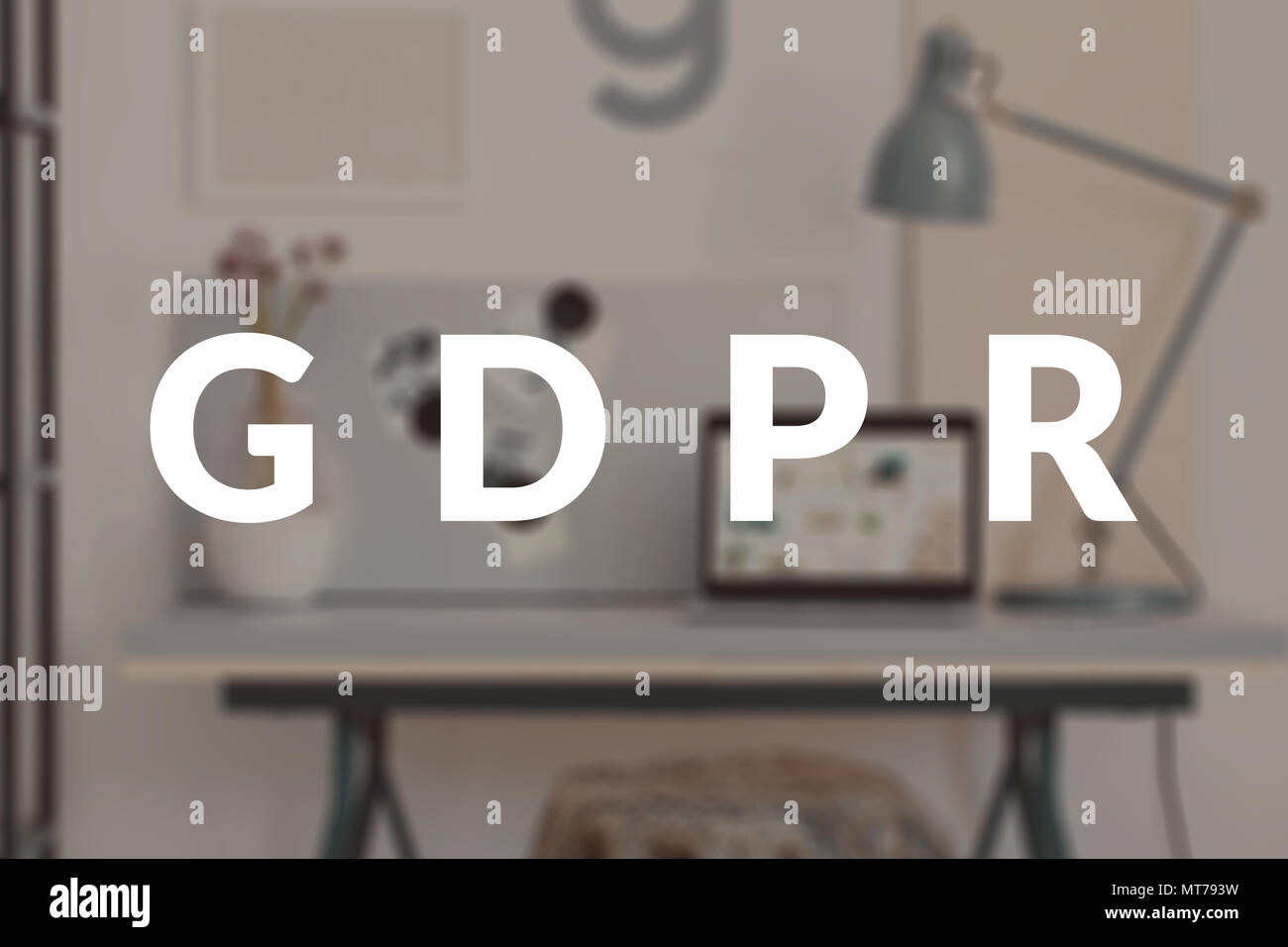 White GDPR text on blurred photo of a desk with laptop. Data security ...