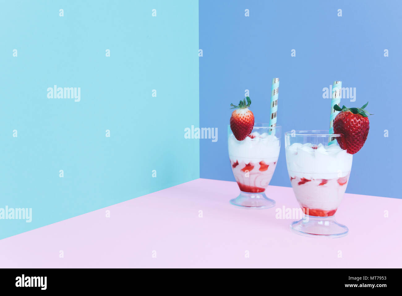 Milkshake with straw and strawberry Stock Photo - Alamy