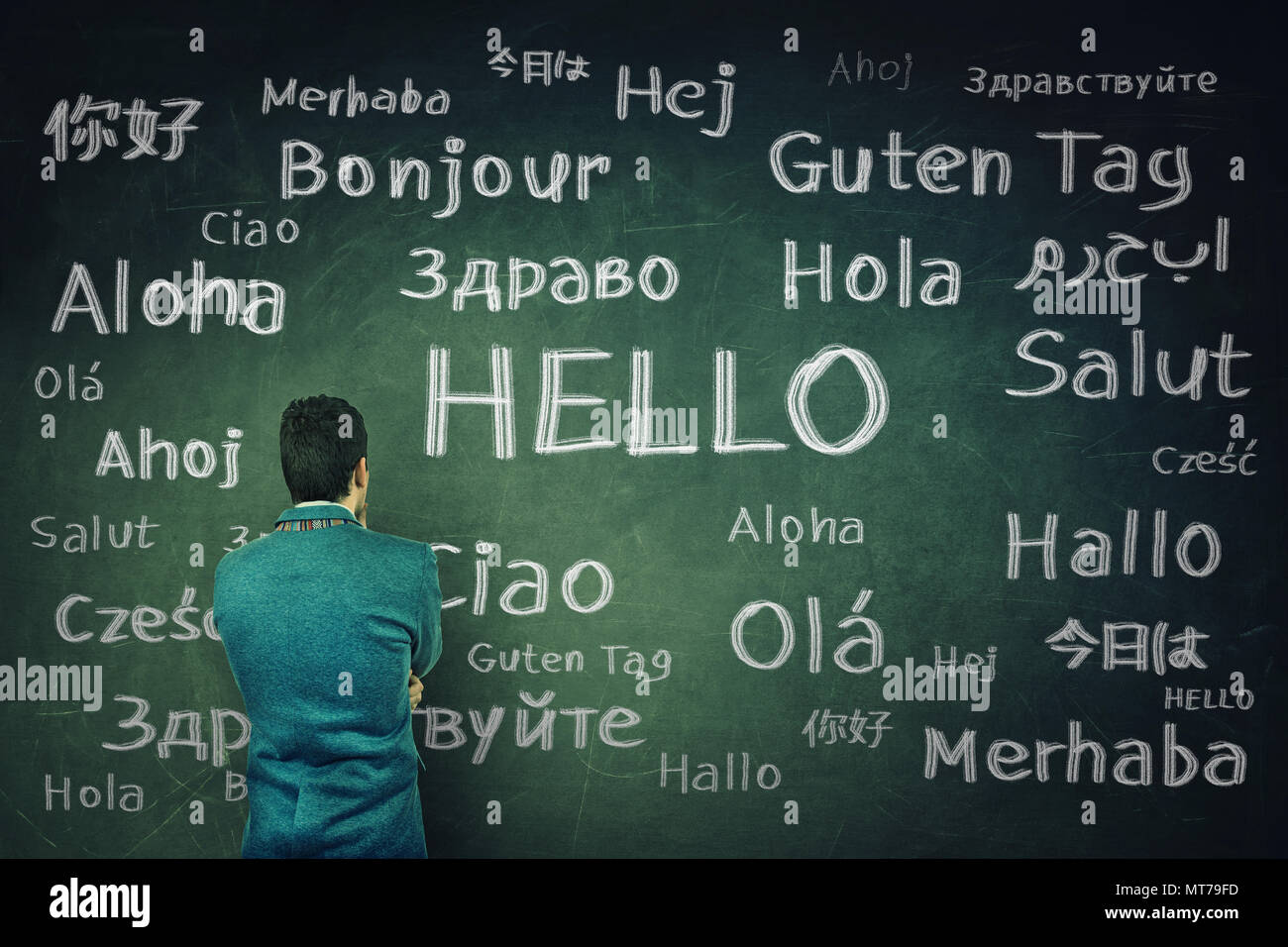 Rear view of a puzzled businessman in front of a huge chalkboard ...