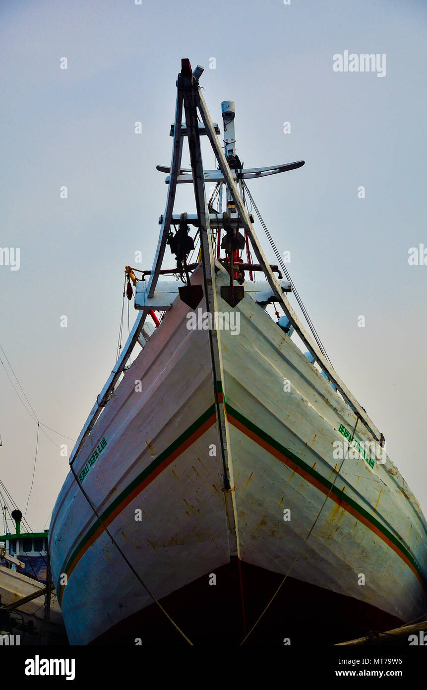 Fisherman and sailor enjoying sunset at a traditional ship boat docking ...