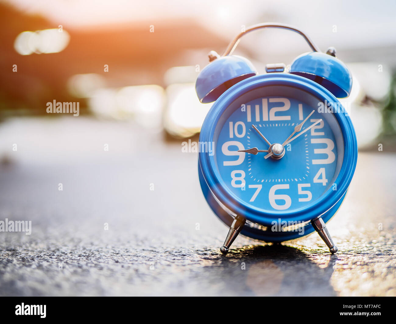 Closeup alarm clock with sunset background Stock Photo - Alamy