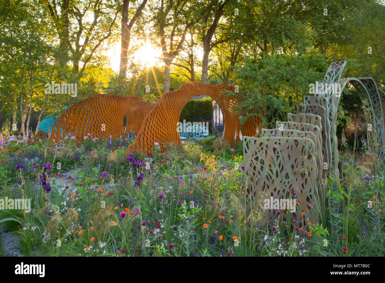 Sunrise over sculptures surrounded by naturalistic planting in the ...
